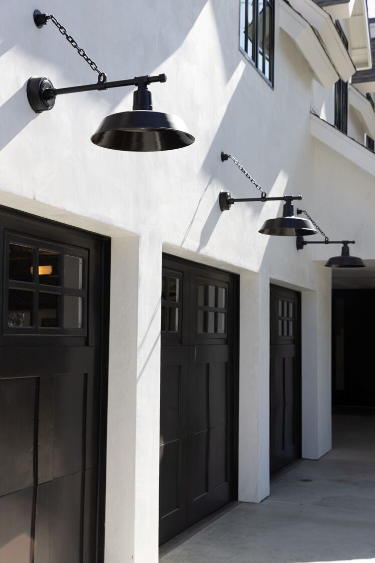 Copper Gooseneck Lights Add Visual Interest to White Façade